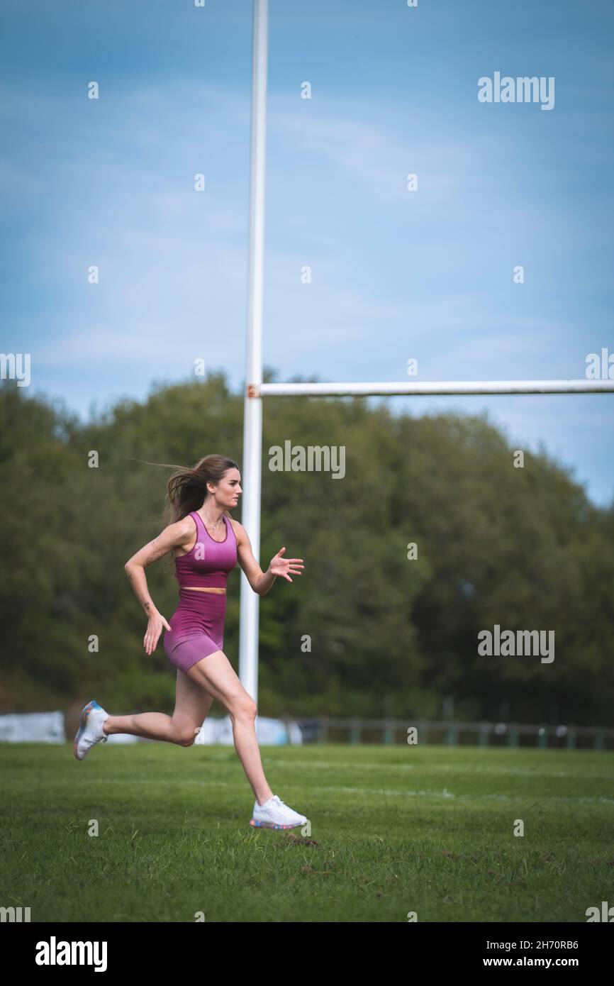 Girl model athlete running on the running track Stock Photo - Alamy