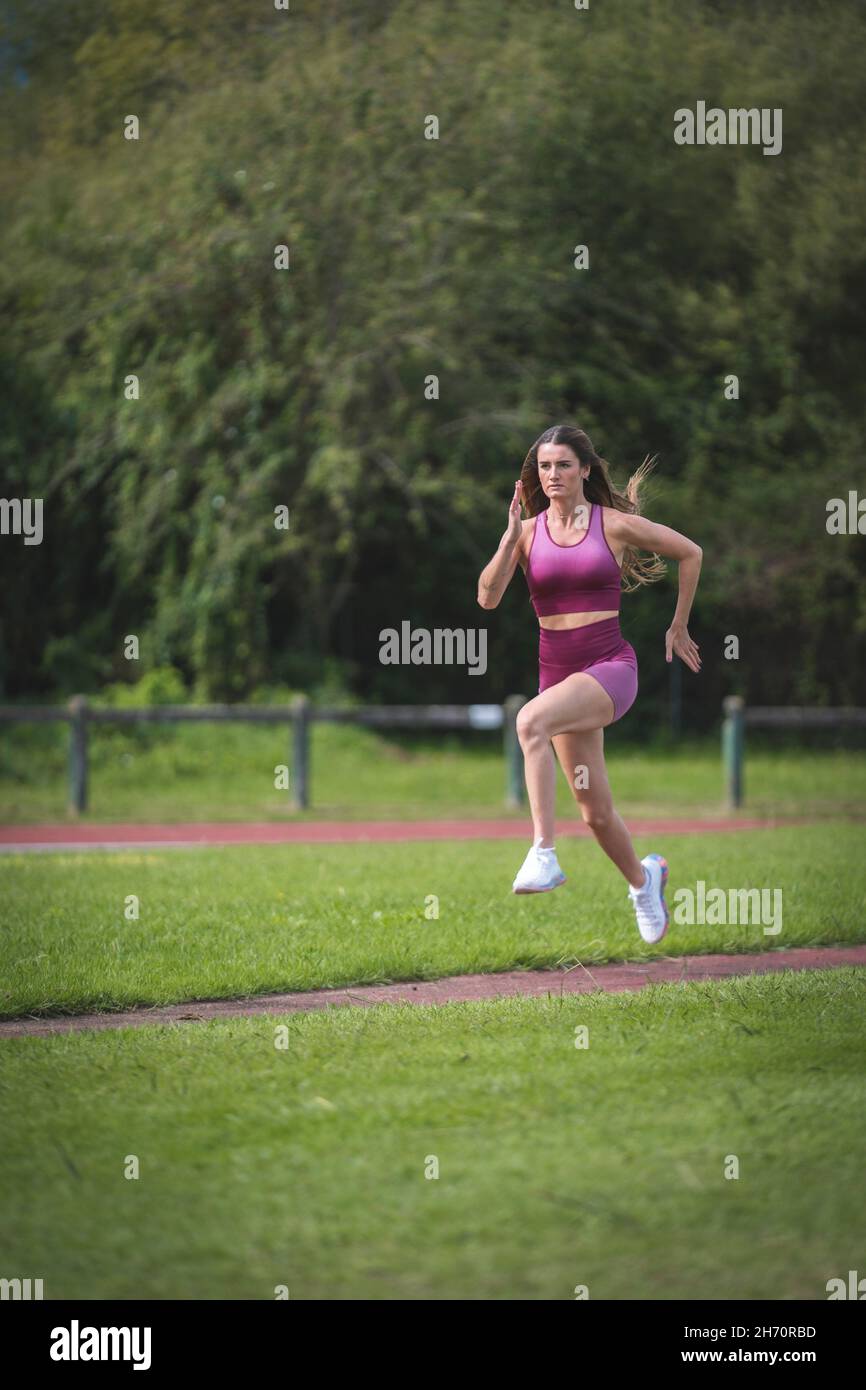Girl model athlete running on the running track Stock Photo - Alamy