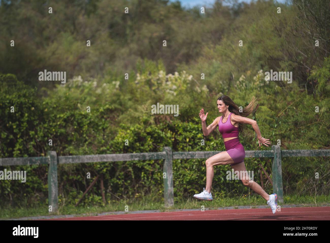 Girl model athlete running on the running track Stock Photo - Alamy