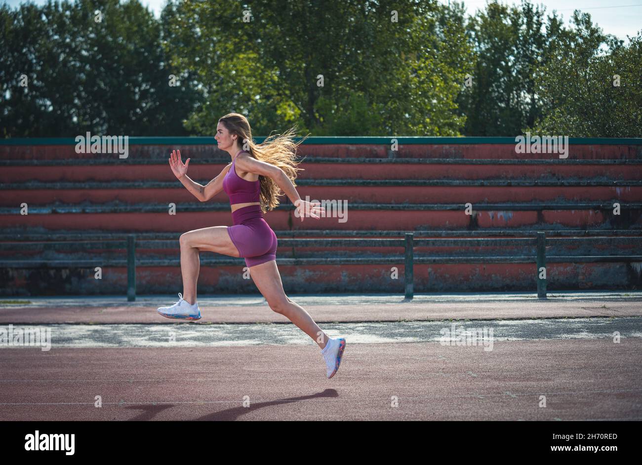 Girl model athlete running on the running track Stock Photo - Alamy