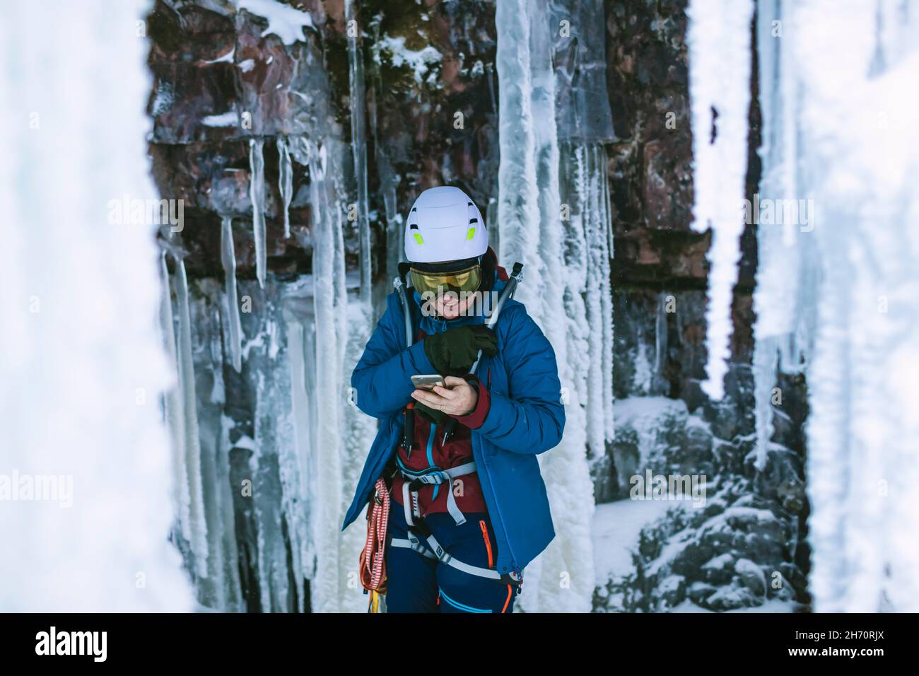 Female ice climber using cell phone Stock Photo - Alamy