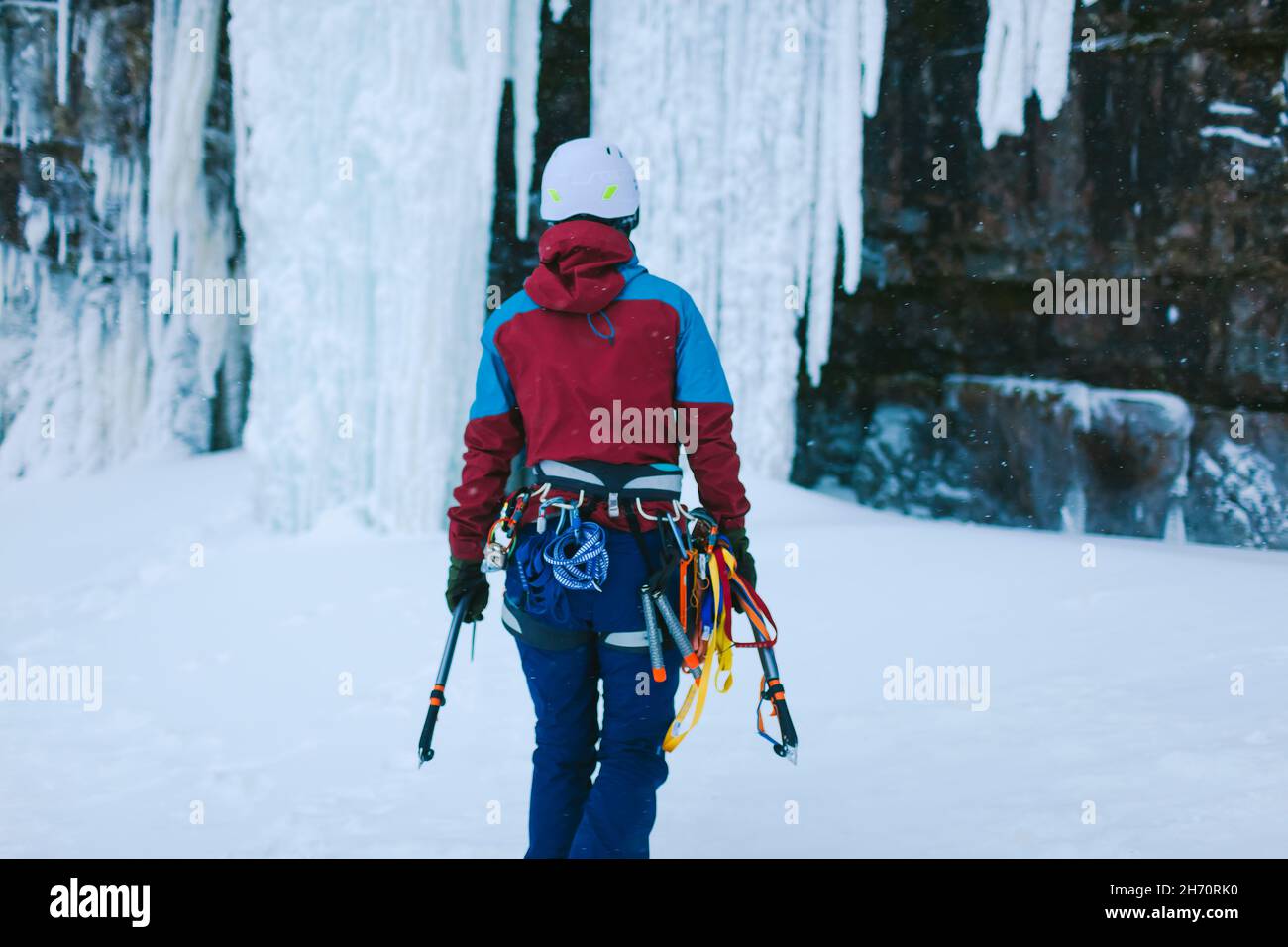 Female ice climber approaching cliff Stock Photo - Alamy