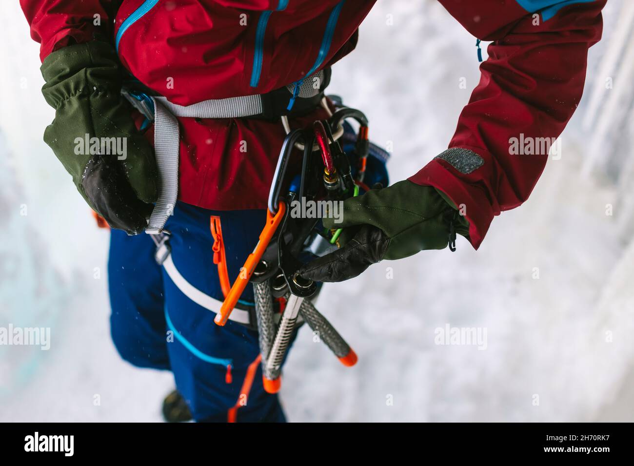 Ice climber checking gear Stock Photo - Alamy