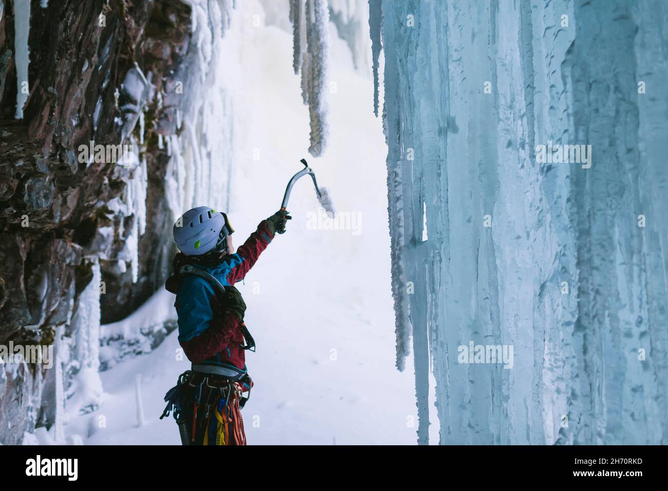 Female ice climber holding equipment Stock Photo - Alamy
