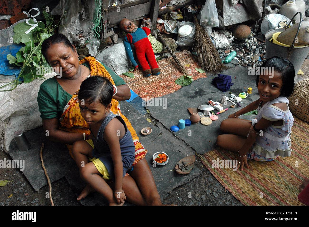 A poor family seated near their house. India Stock Photo - Alamy