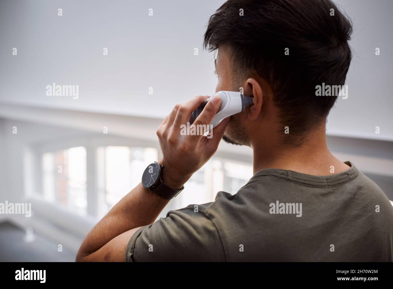 Man checking temperature with digital thermometer Stock Photo - Alamy