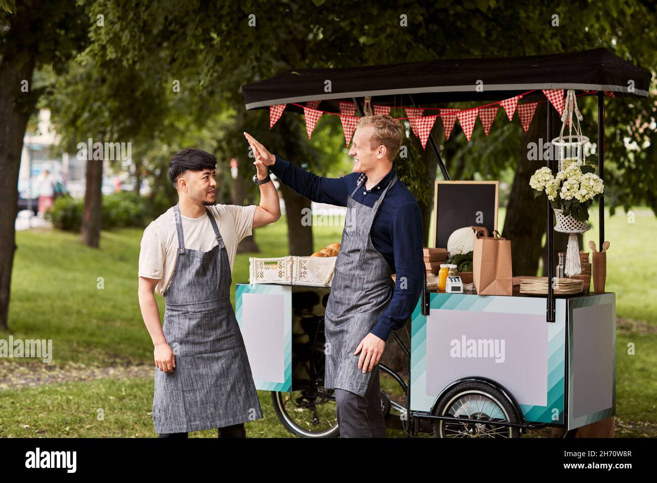 Men at food stall Stock Photo - Alamy