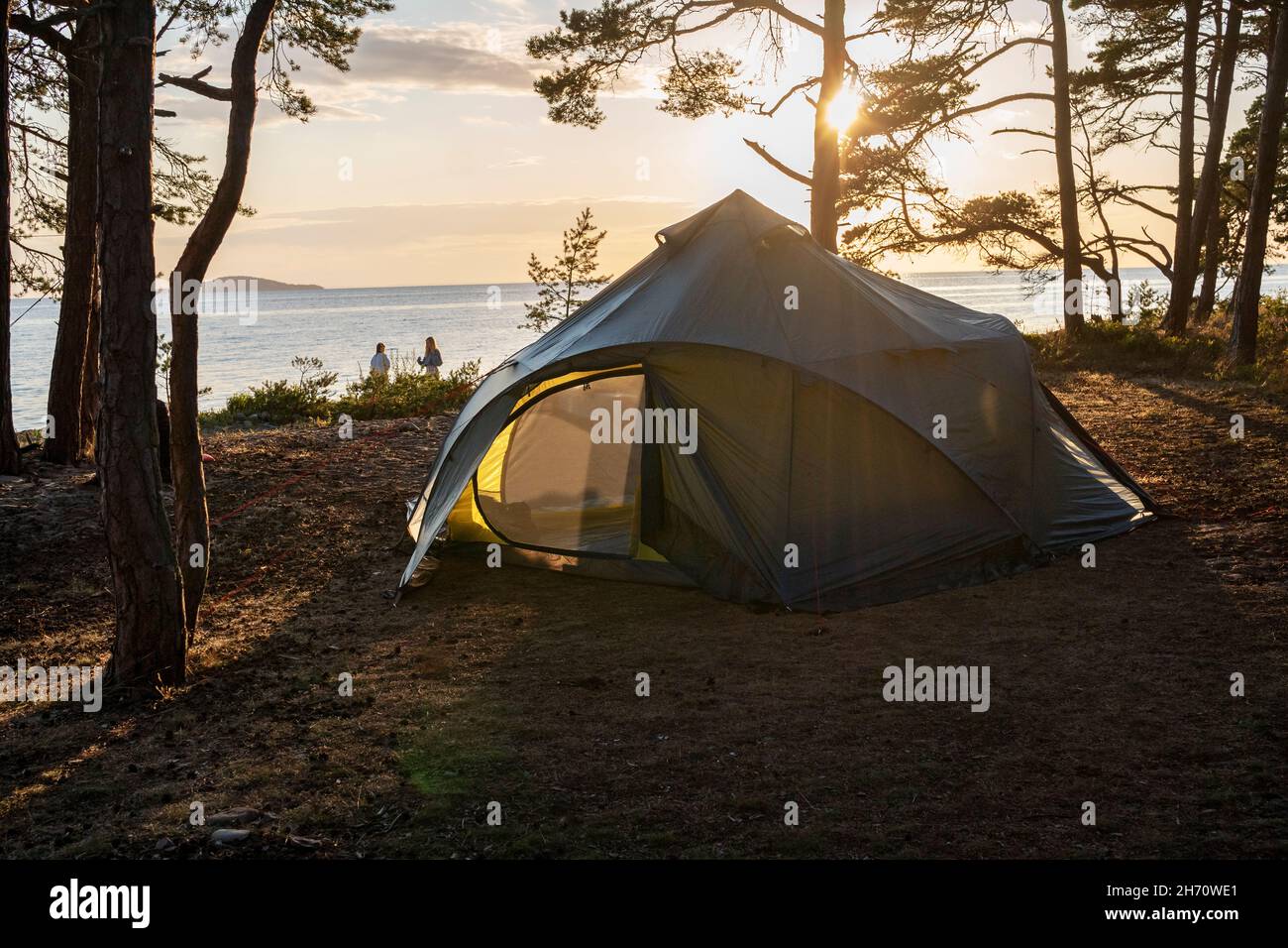 Tent at seaside at sunset Stock Photo - Alamy