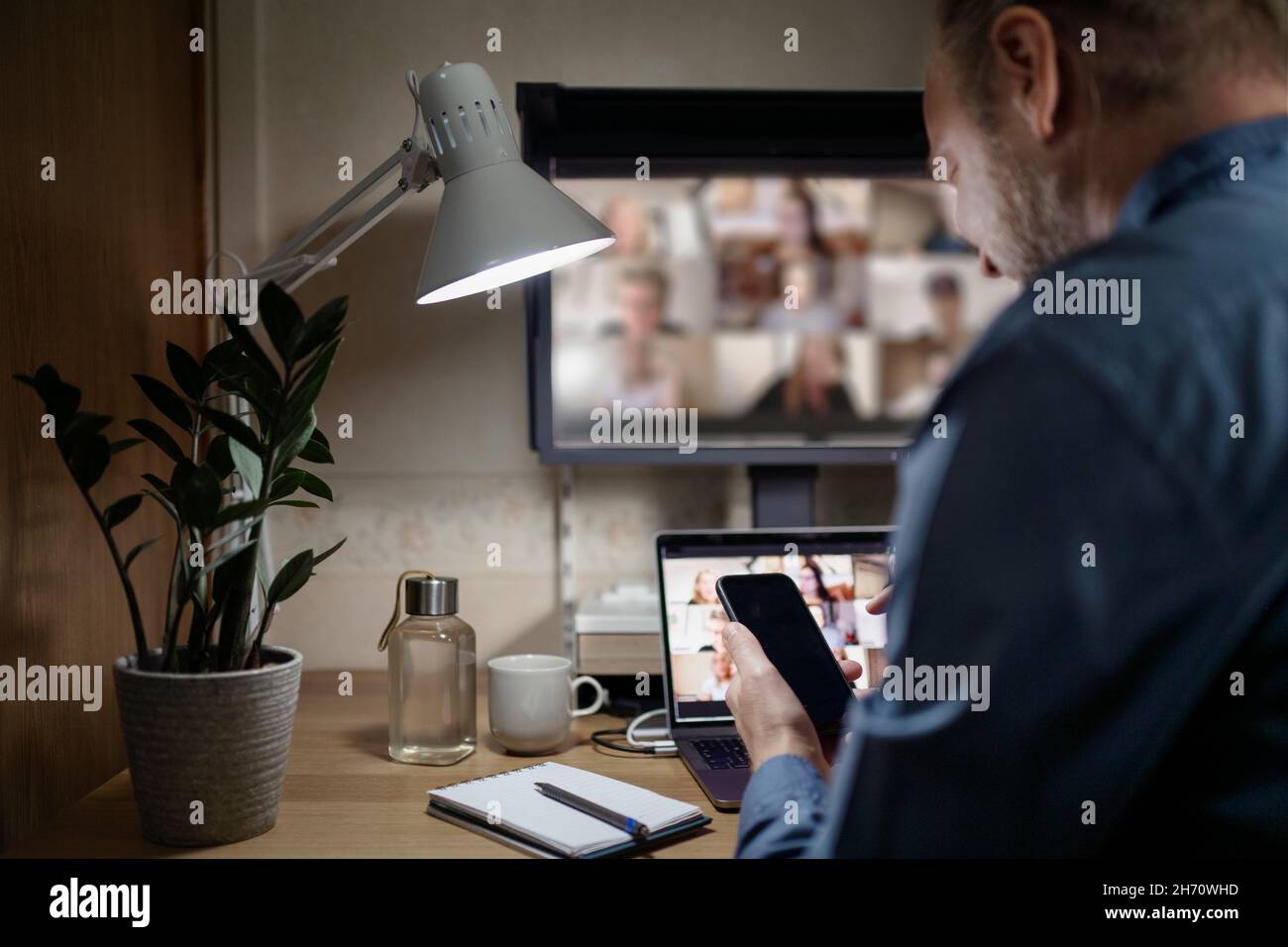 Man attending video conference from home Stock Photo - Alamy