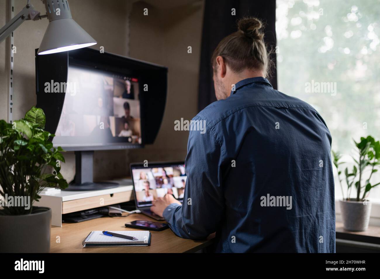 Man attending video conference from home Stock Photo - Alamy