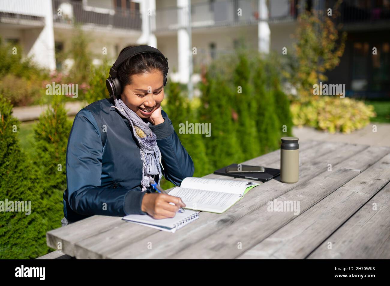 Young woman learning at courtyard Stock Photo - Alamy