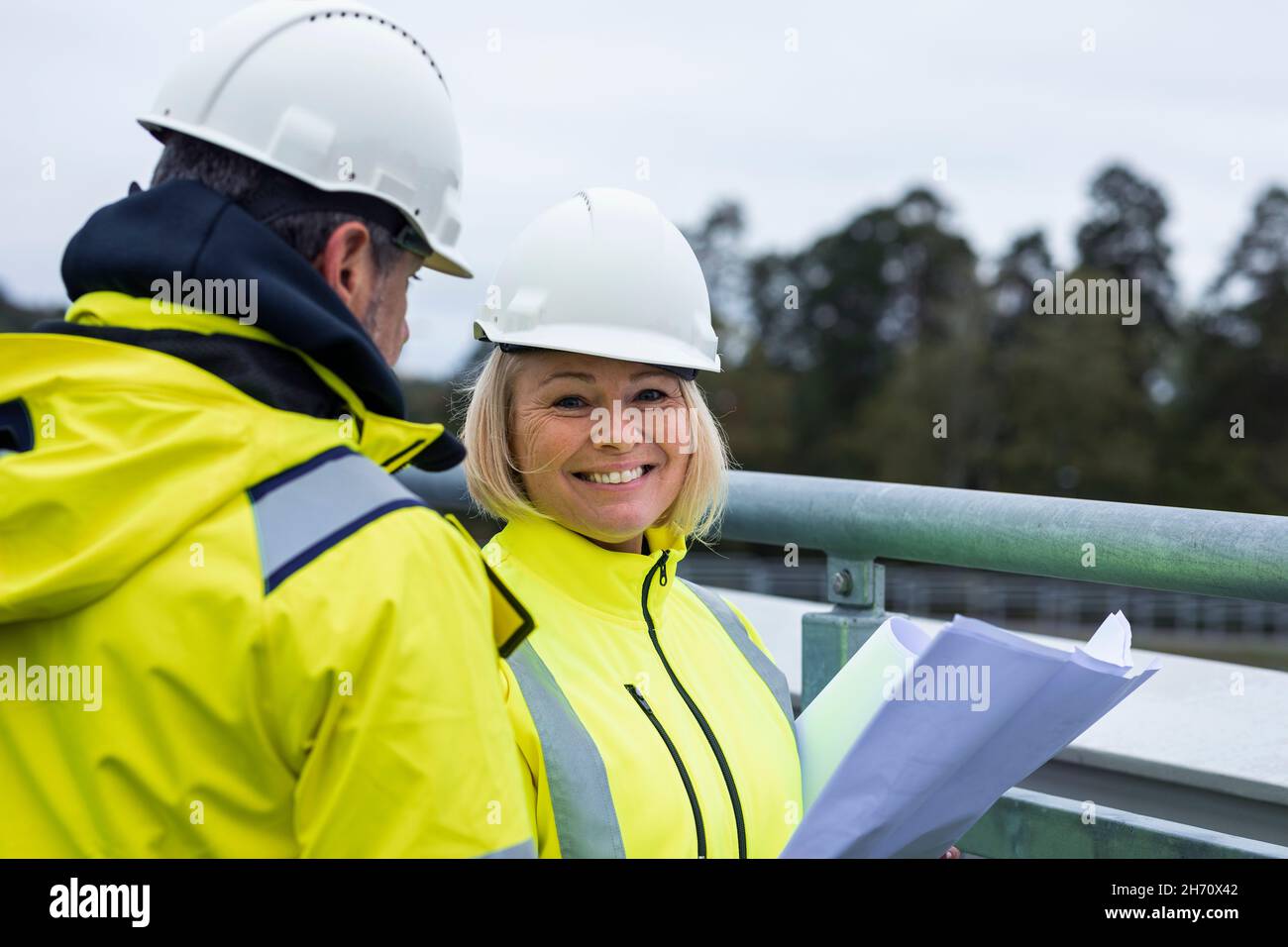 People talking on building site Stock Photo - Alamy