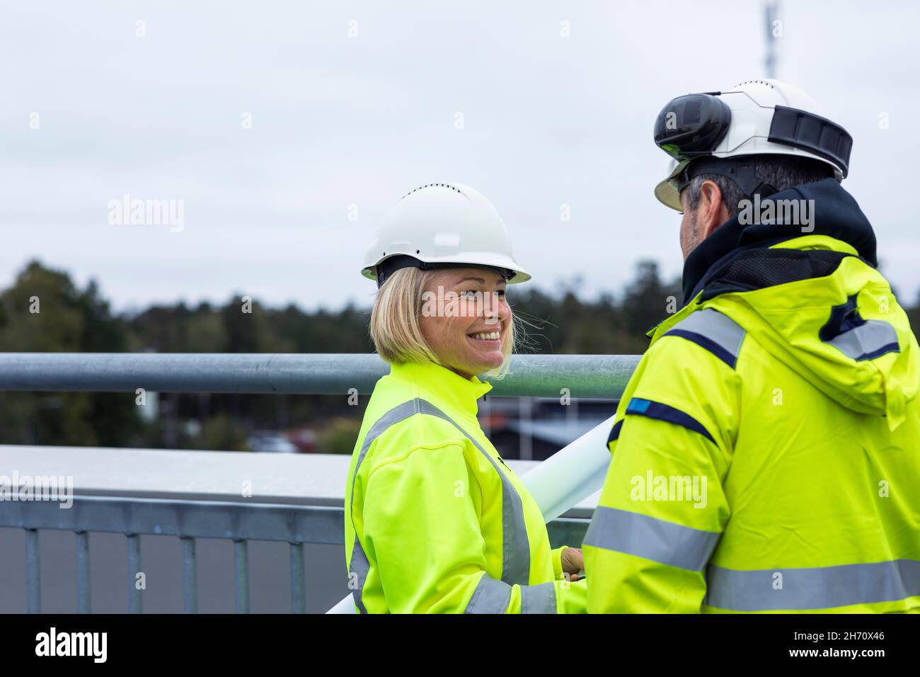 People talking on building site Stock Photo - Alamy