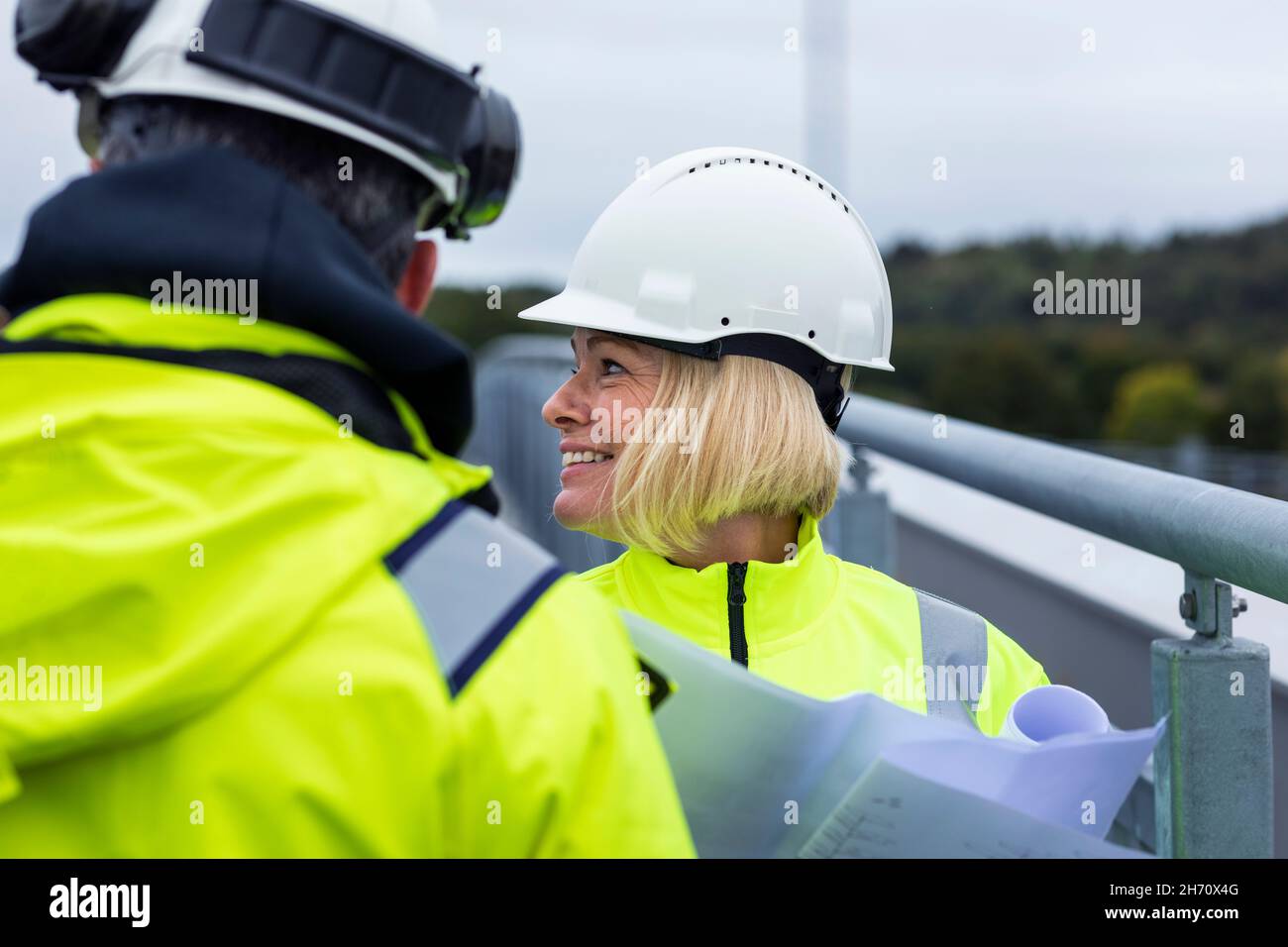 People talking on building site Stock Photo - Alamy