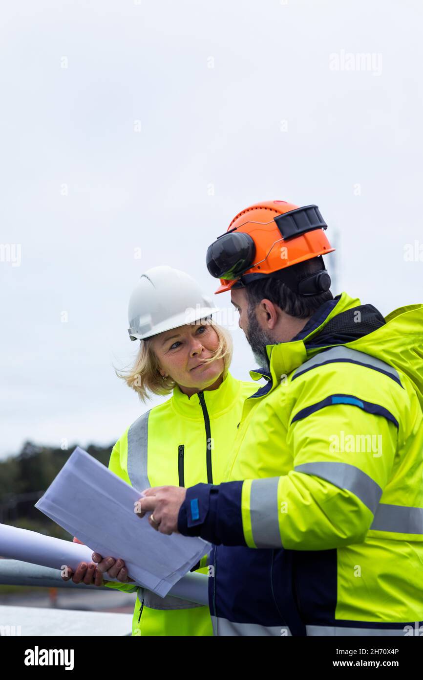 People talking on building site Stock Photo - Alamy