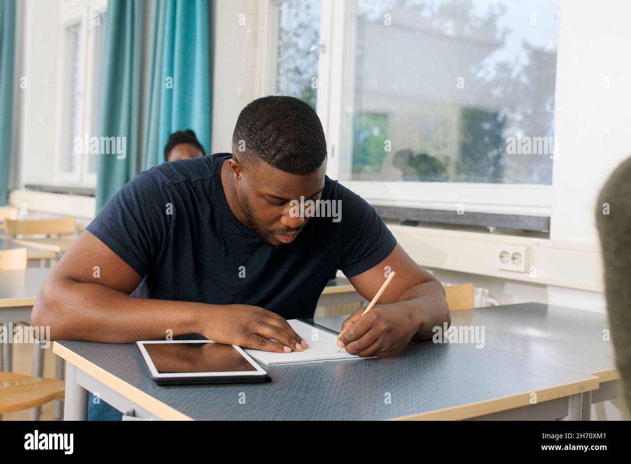 Student writing during classes Stock Photo - Alamy