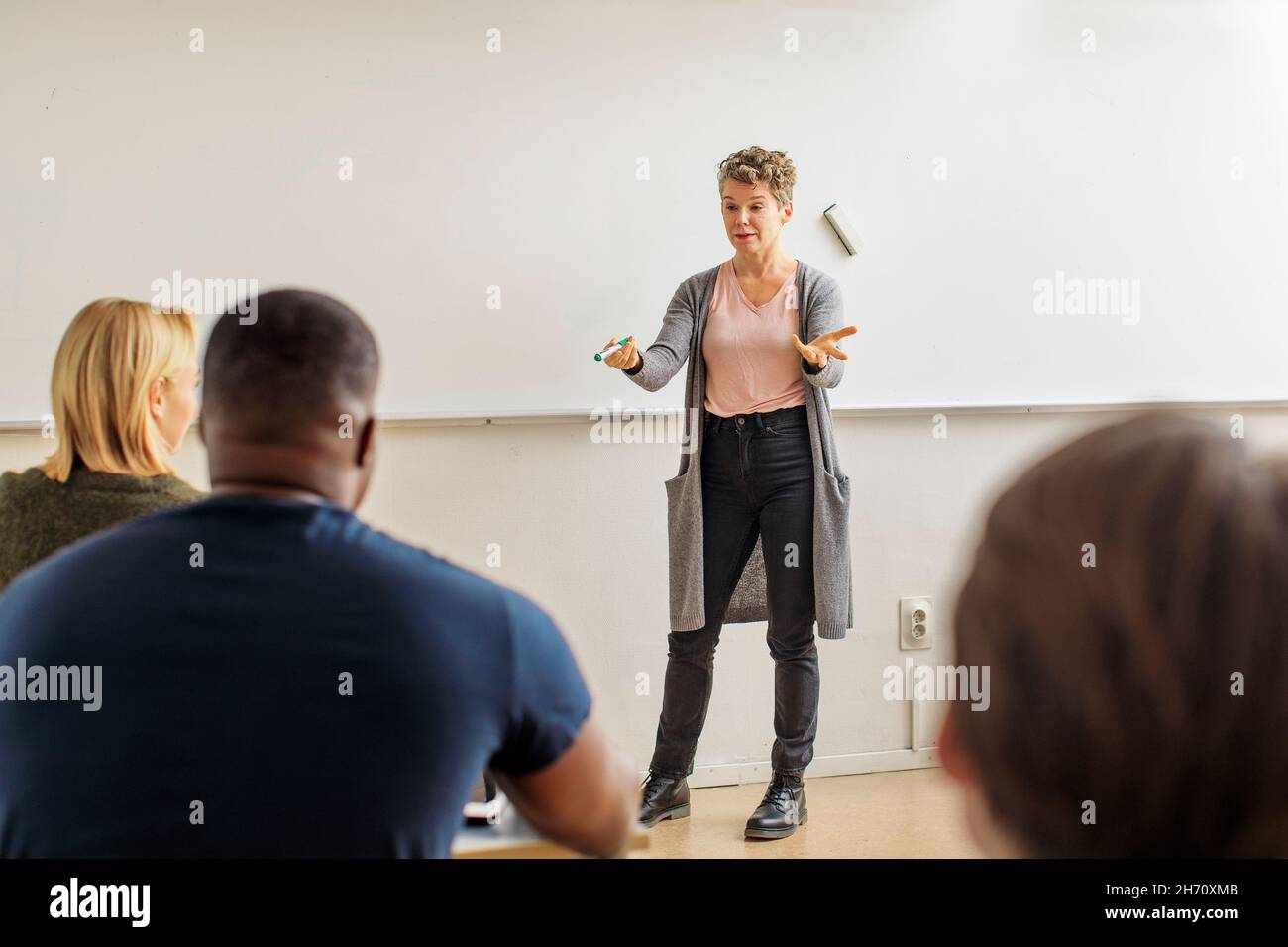 Teacher giving lecture in classroom Stock Photo - Alamy