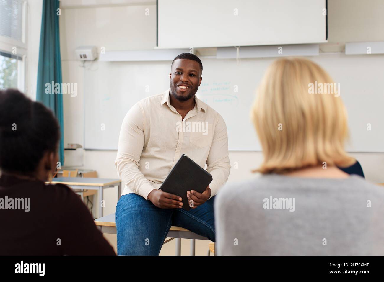 Teacher giving lecture in classroom Stock Photo - Alamy