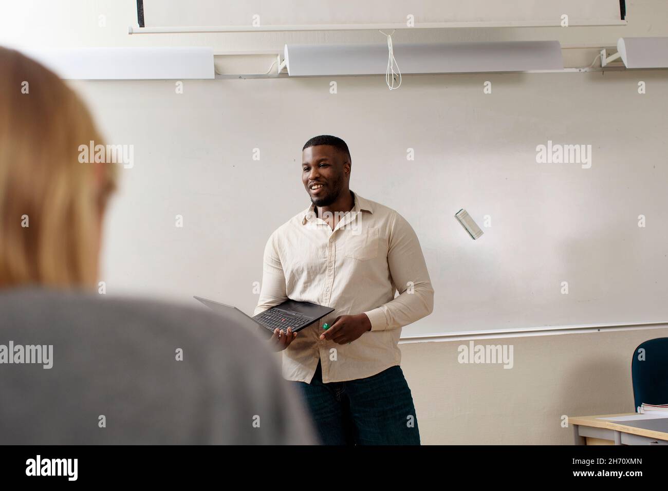 Teacher giving lecture in classroom Stock Photo - Alamy