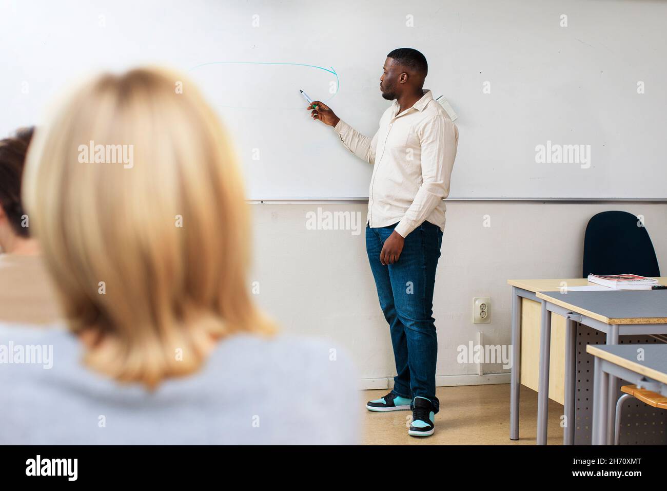 Teacher giving lecture in classroom Stock Photo - Alamy