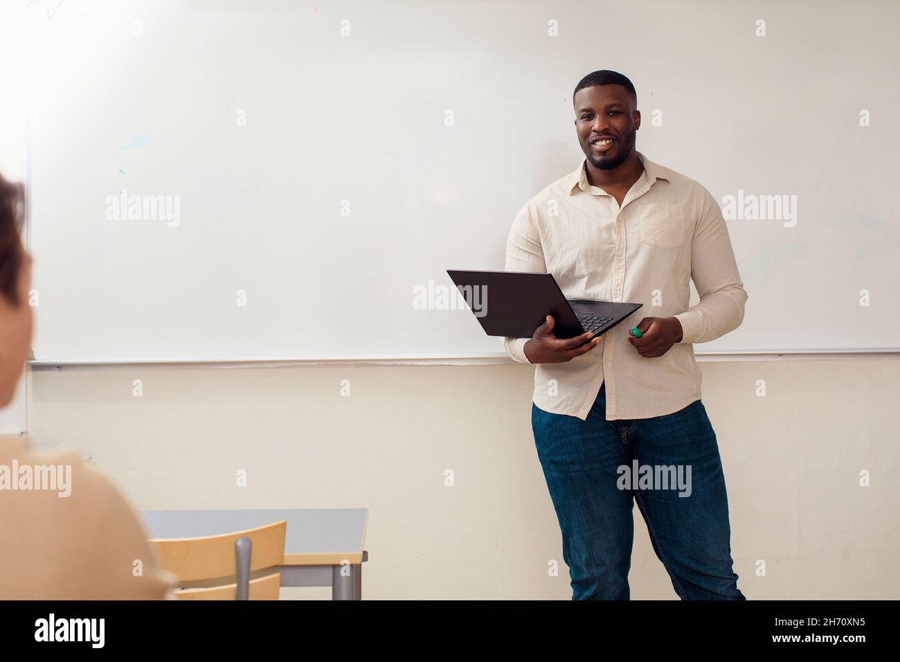 Teacher giving lecture in classroom Stock Photo - Alamy
