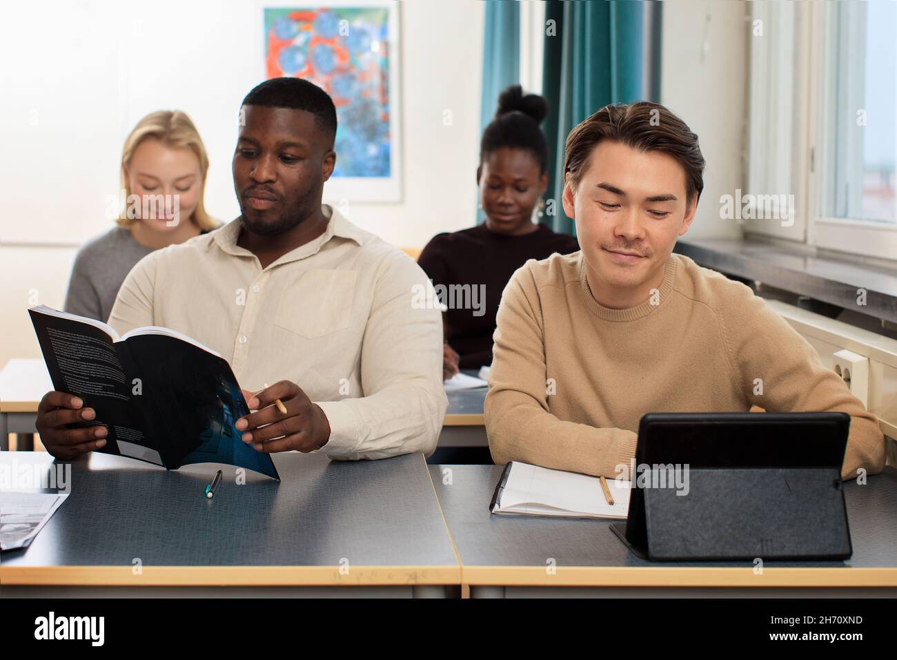 Smiling students in classroom Stock Photo - Alamy