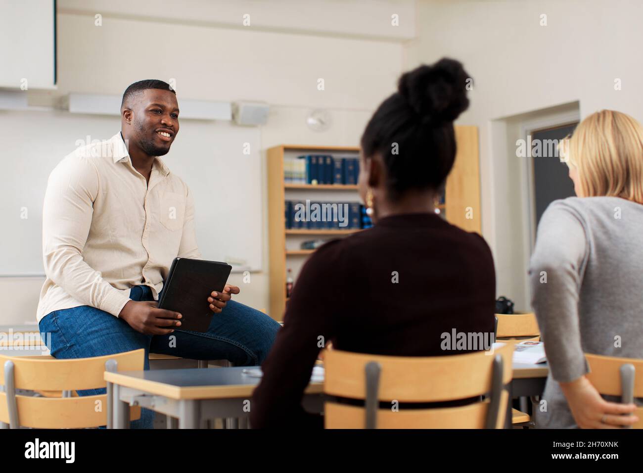 Teacher giving lecture in classroom Stock Photo - Alamy