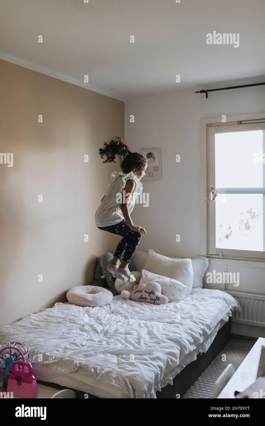 Kid jumping bed hi-res stock photography and images - Alamy