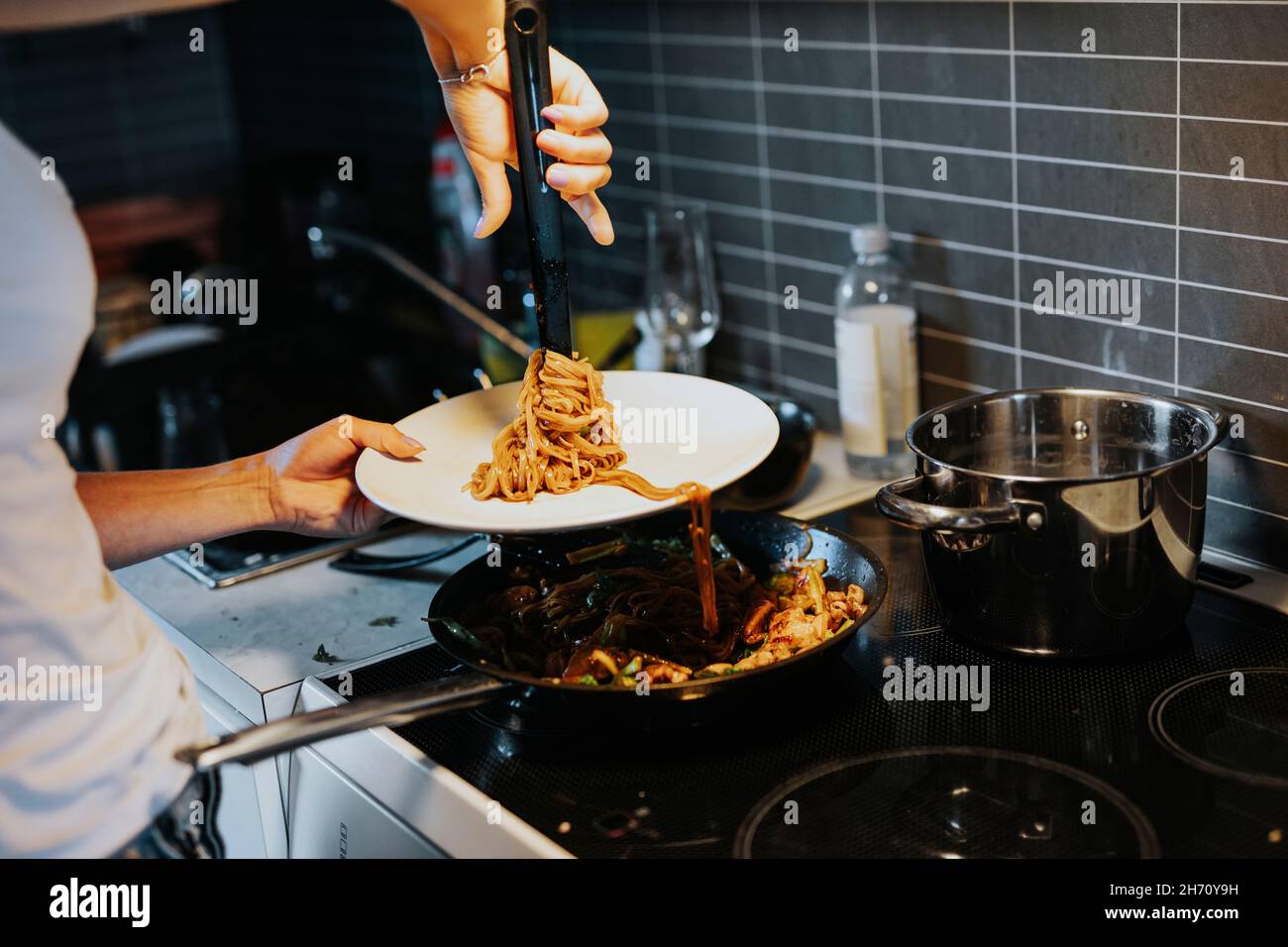 Woman putting plate pasta hi-res stock photography and images - Alamy