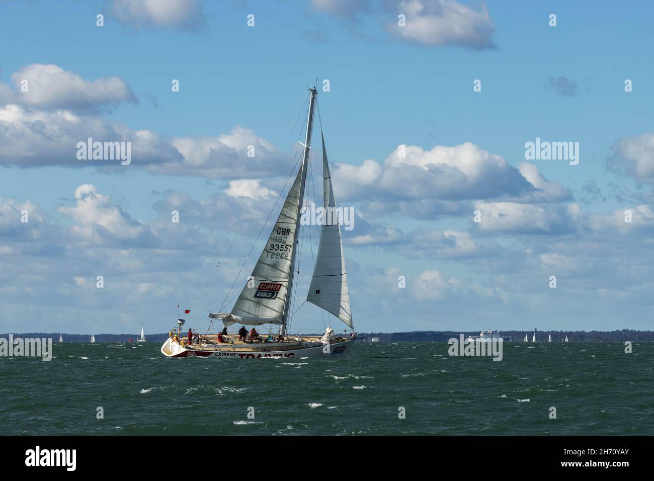 Training sailing boat with full sails in Solent Stock Photo - Alamy
