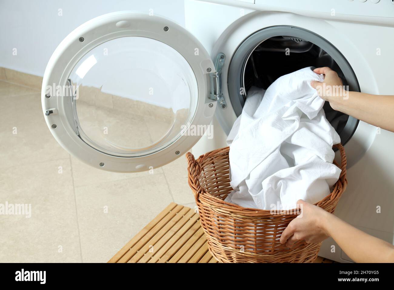 Concept of housework with washing machine against white wall Stock ...