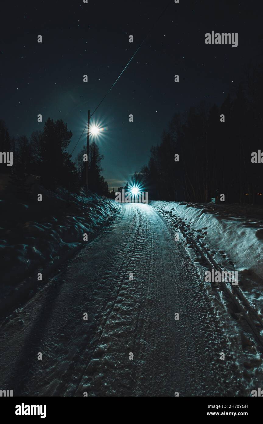 Snowy road at night Stock Photo - Alamy