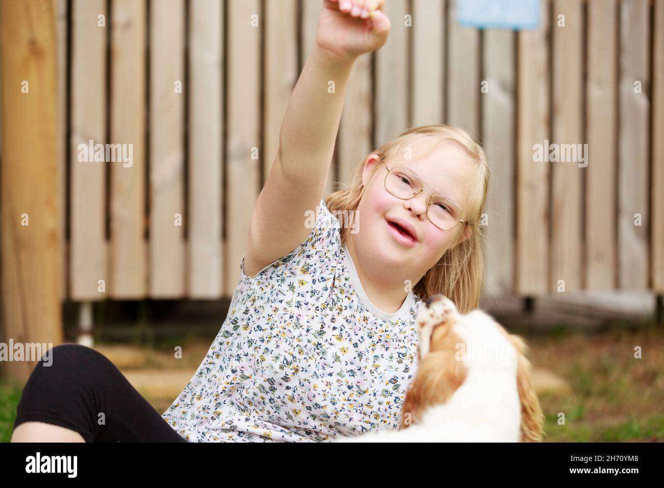 Portrait of girl raising hand Stock Photo - Alamy