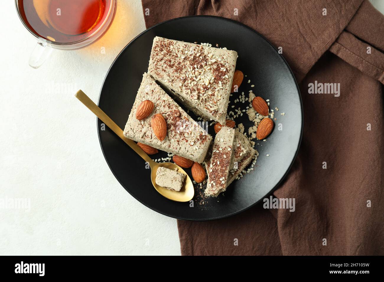 Concept of tasty food with halva on white textured background Stock Photo - Alamy