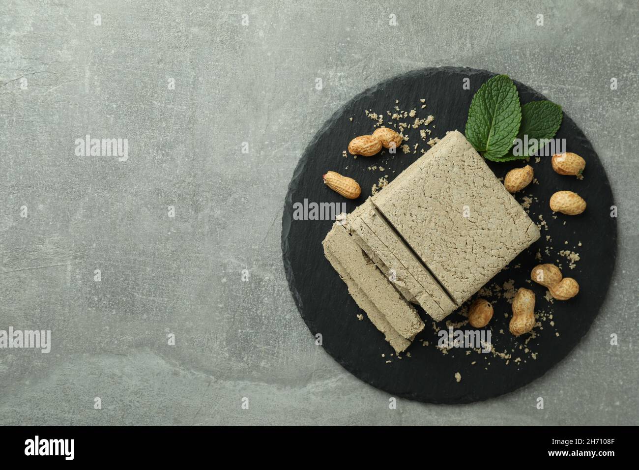 Concept of tasty food with halva on gray textured background Stock Photo - Alamy