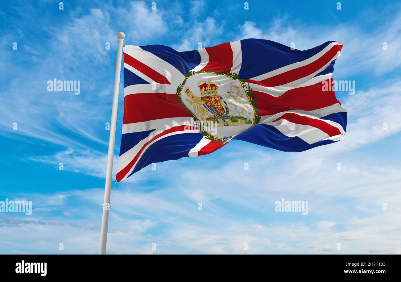 flag of British Ambassador Ensign at cloudy sky background on sunset ...