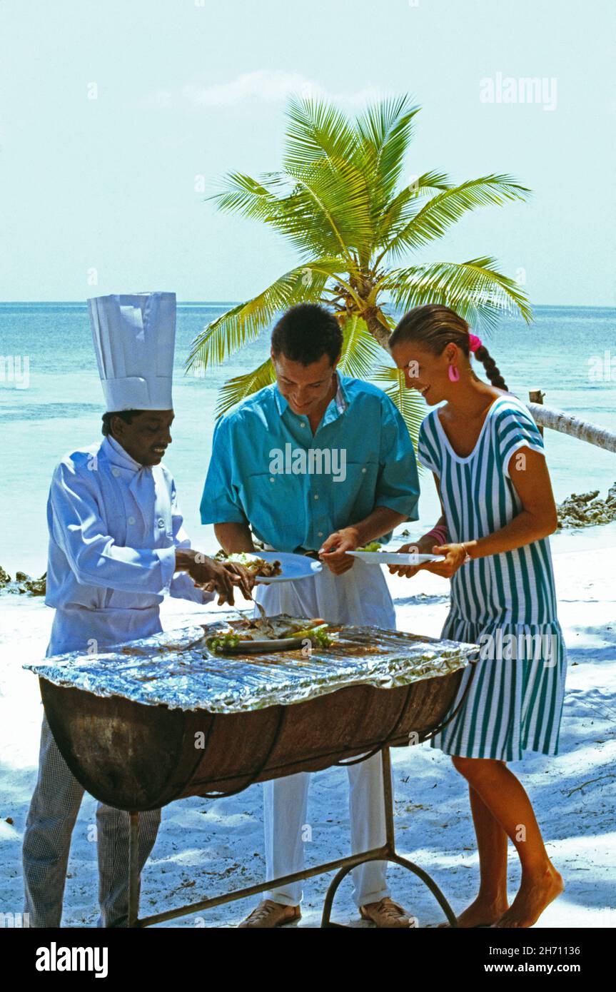 Maldives. Hotel chef serving lunch to young couple on the beach Stock ...