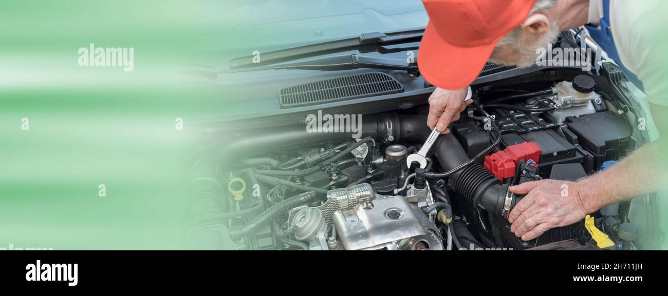 Car mechanic repairing a car engine Stock Photo - Alamy