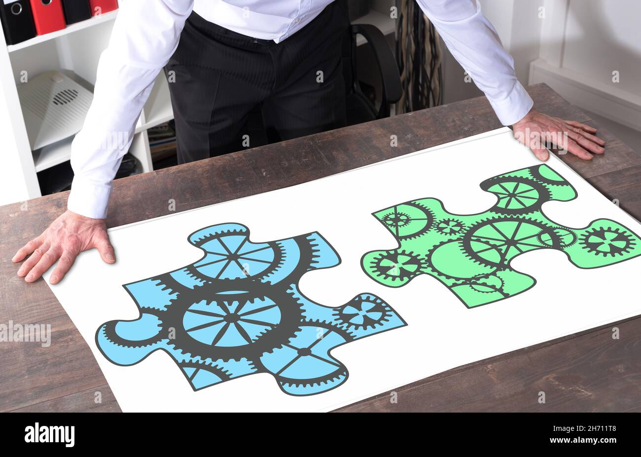 Man watching a teamwork concept placed on a desk Stock Photo - Alamy