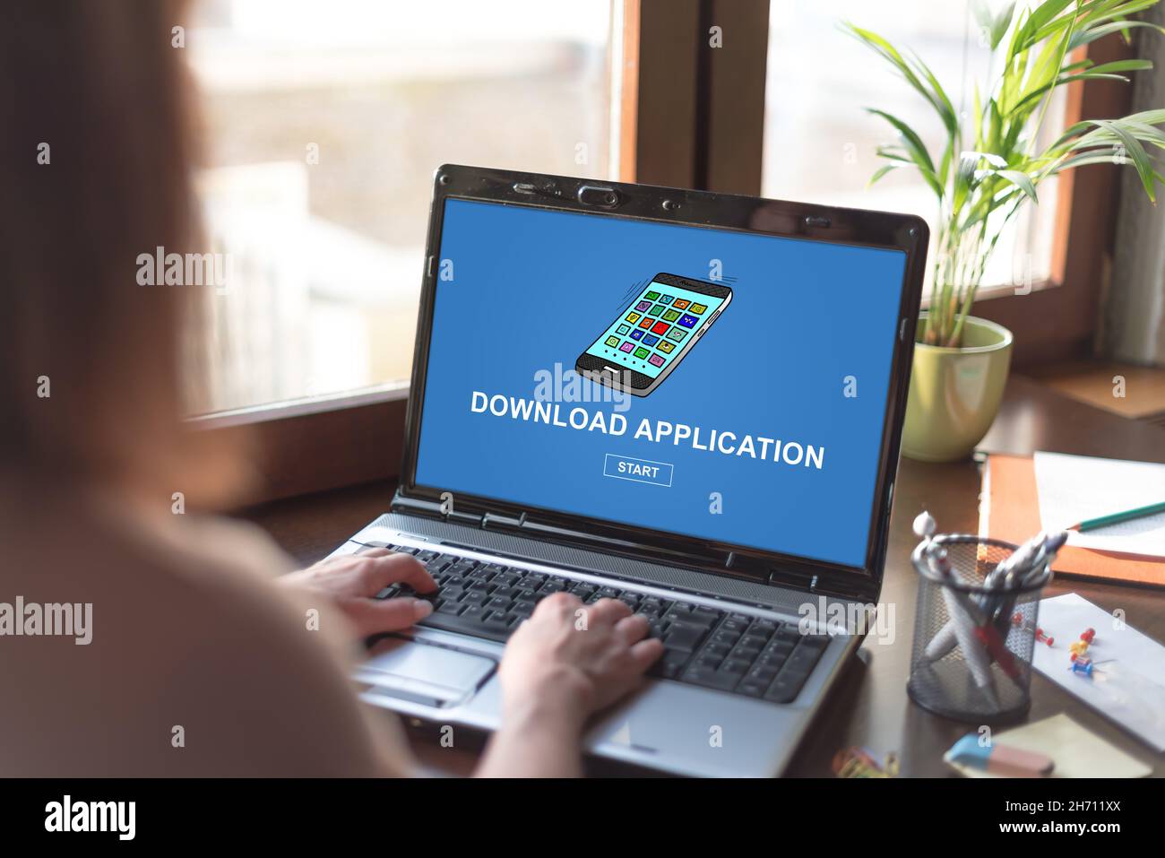 Laptop screen displaying a download application concept Stock Photo - Alamy