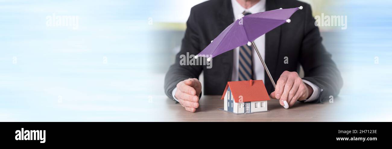 Insurer protecting a model house, concept of insured house Stock Photo ...