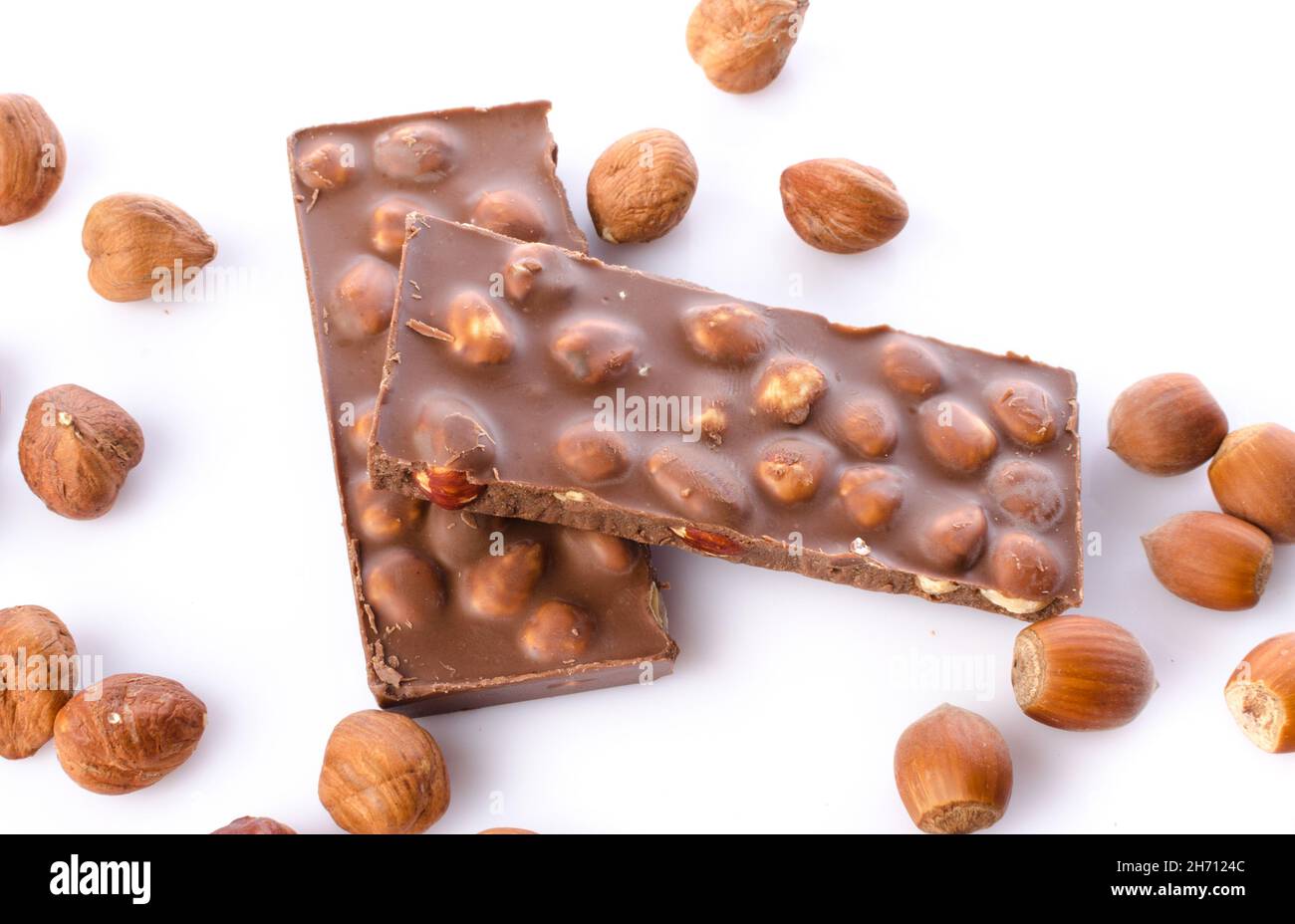 Chocolate with hazelnuts, isolated on white Stock Photo - Alamy