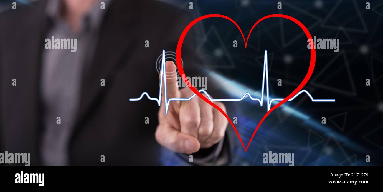 Man touching a heart beats graph on a touch screen with his finger ...