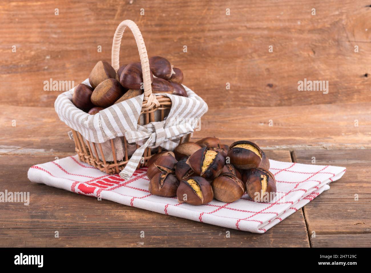 Raw and roasted chestnuts on a towel Stock Photo - Alamy