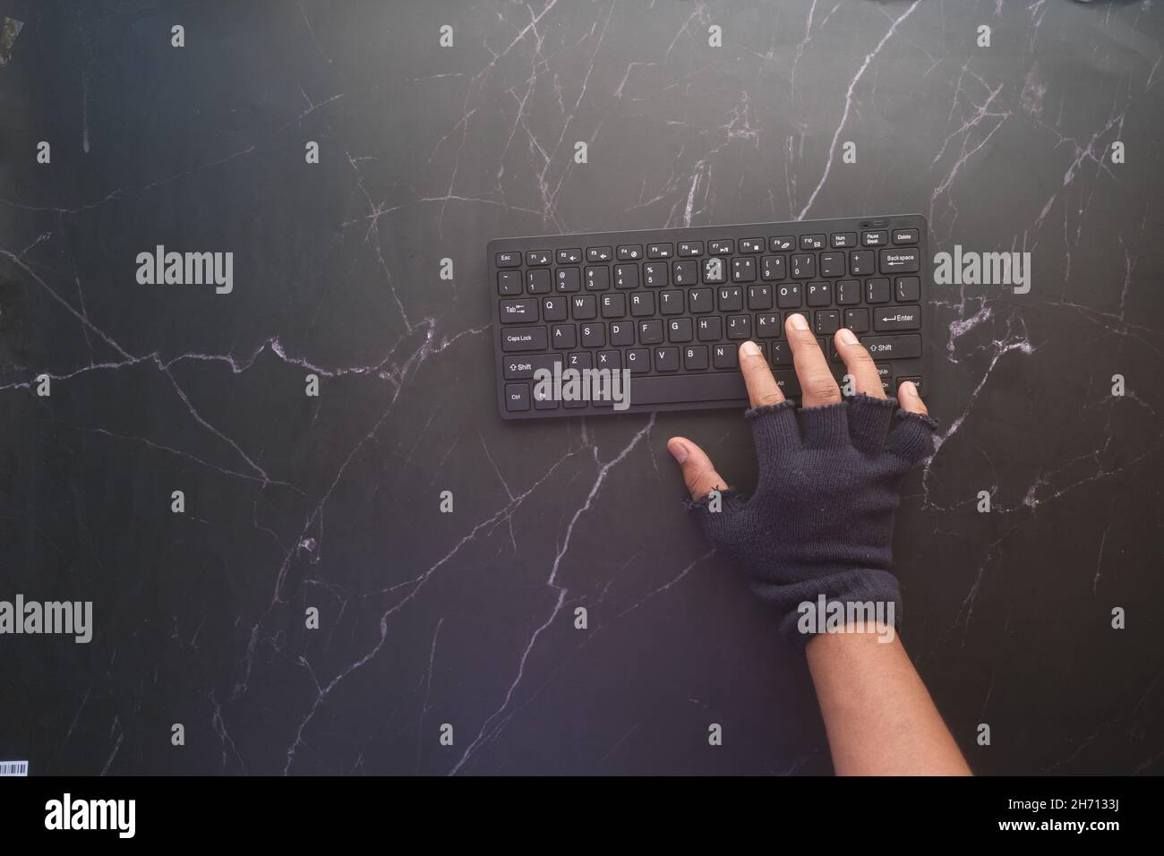 hacker hand stealing data from laptop top down Stock Photo - Alamy