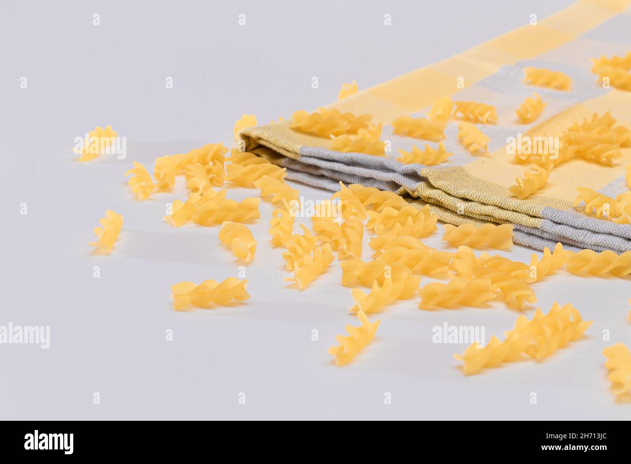 Uncooked Fusilli Pasta Scattered on White Table. Raw and Dry Macaroni ...