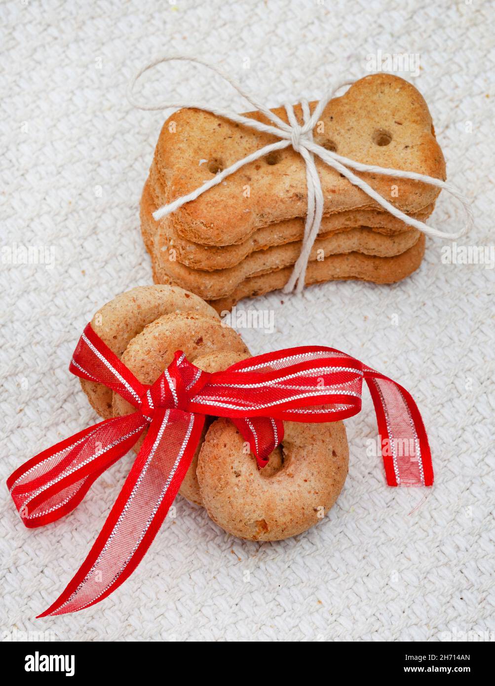 Different shapes of dog treat biscuits on light and neutral tabletop ...