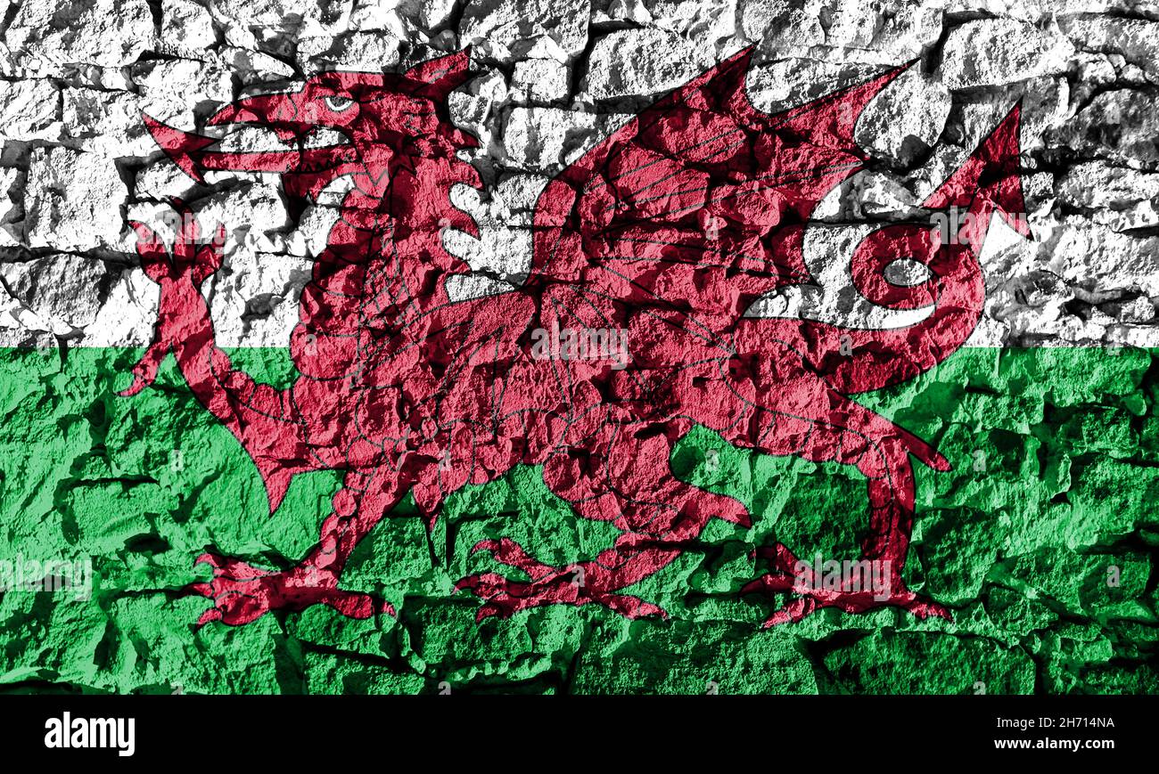 Wales flag depicted on a stone wall. The texture of the stone blends ...