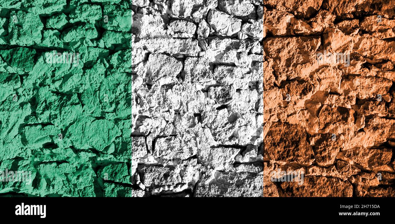 Ireland flag depicted on a stone wall. The texture of the stone blends ...
