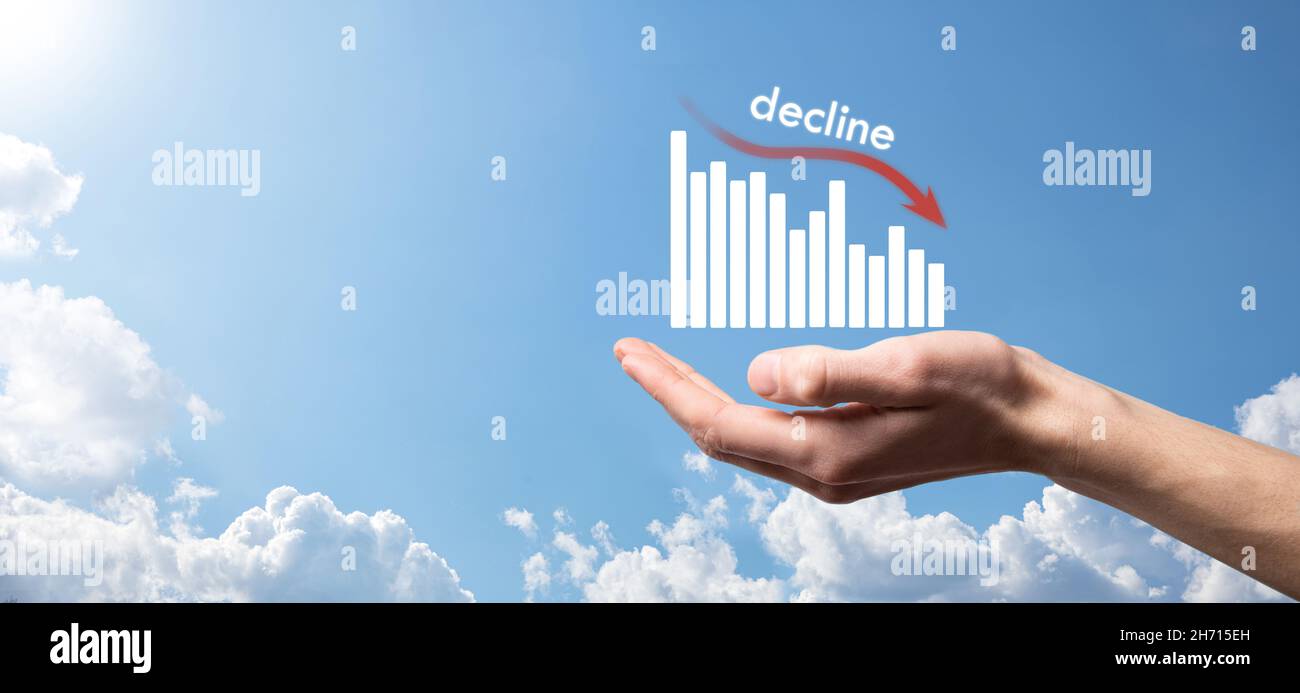 Business man holding holographic graphs and stock.Decline, decrease ...